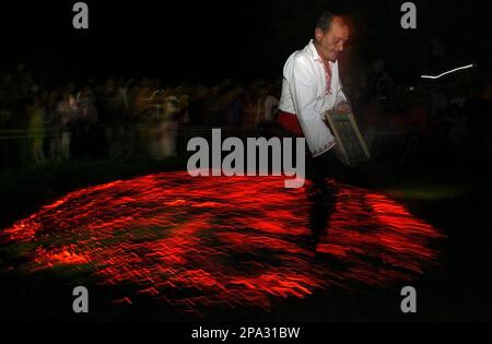 Bulgarian Nestinari dancer performs barefoot over smoldering embers as ...