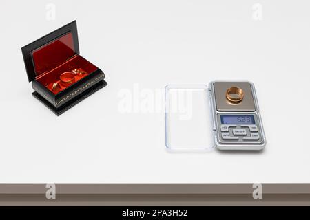 scales for small items are on the table. jewelry scale. golden ring ...