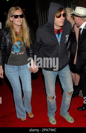 Singer Evan Dando, right, and model Elizabeth Moses walk the press line at the NME Awards USA in ...