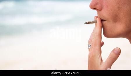 woman smoking a joint on the beach Stock Photo - Alamy