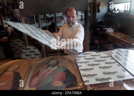 North Carolina Museum of Art conservator David Beaudin inspects the ...