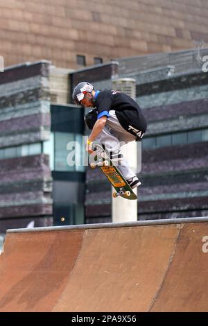 Members of Team Extreme performing Skateboard tricks on the half pipe ...