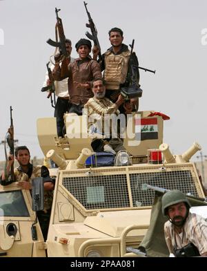 Mahdi Army fighters drive away with captured Iraqi police vehicles ...