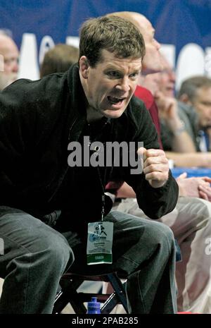 Iowa's head coach Tom Brands cheers after first seeded Brent Metcalf ...