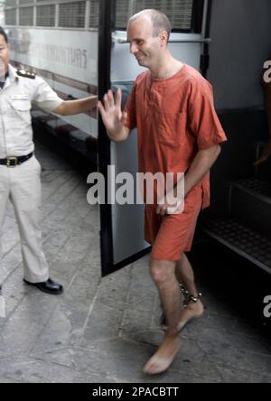 Canadian pedophile suspect Christopher Paul Neil, center, walks with ...