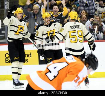 Philadelphia Flyers' Owen Tippett (74) battle for the puck with ...