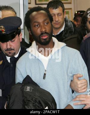 Rudy Hermann Guede, of the Ivory Coast, right, is escorted by a ...