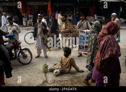 Pakistani beggar on the street Stock Photo - Alamy
