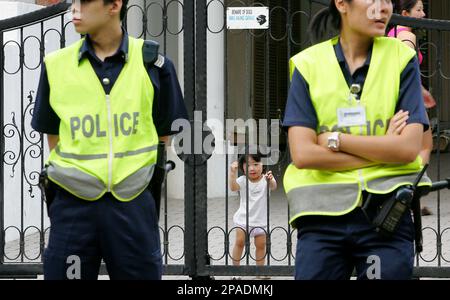 Police officers from the Singapore Police Force patrol in a subway ...