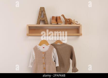 Baby booties with toys on brown background. Different color patterns ...