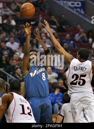 Philadelphia 76ers' Rodney Carney, right, is fouled by Phoenix Suns ...