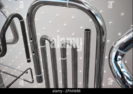 Shiny steel pipes on display in contemporary hardware store Stock Photo - Alamy