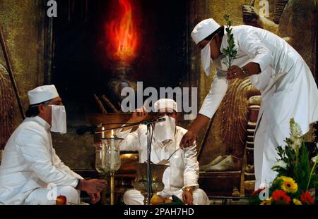 Ancient Persian priests in white robes performing ritual sacrifices at ...