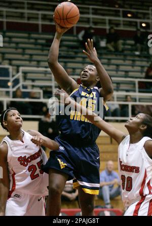 West Virginia's Olayinka Sanni (45) takes a shot while being guarded by ...