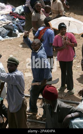 A member from the feared Kikuyu criminal gang, the Mungiki ,tries to ...
