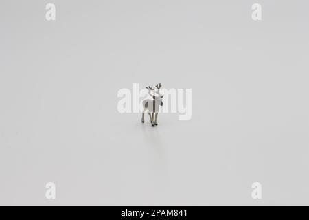 a close up of a miniature figure of a moose isolated on a white ...