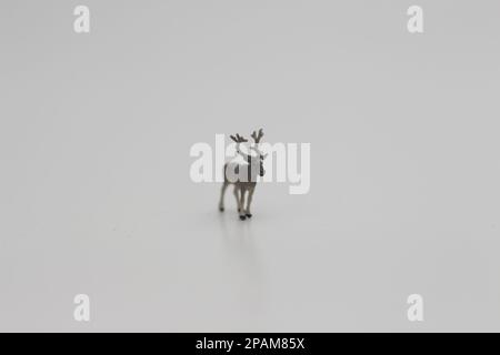 a close up of a miniature figure of a moose isolated on a white ...