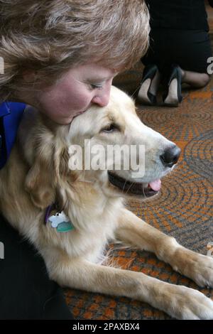Debbie Parkhurst, of North East, Md., poses with her golden retriever ...