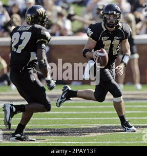 Wake Forest's Riley Skinner (11) throws a pass as he is pressured by ...