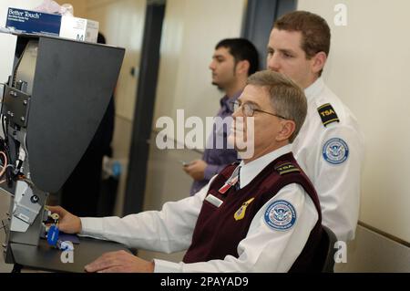 Airport security officer x ray baggage scanning Stock Photo - Alamy