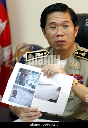 Keo Vannthan, Director of Cambodia's Interpol bureau, shows pictures ...