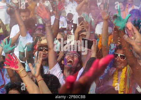 Pattaya, Thailand. 11th Mar, 2023. People play with colored powder to ...