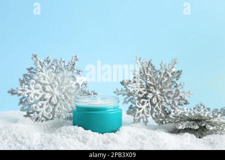 Jar with cream and snowflakes on color background Stock Photo - Alamy