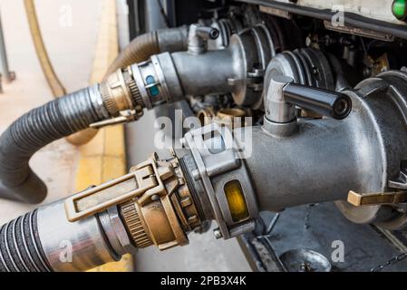 Devices attached to the mouths of a tanker truck to connect the ...