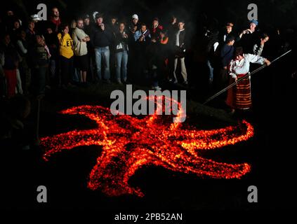 Bulgarian Nestinari dancer performs barefoot over smoldering embers as ...