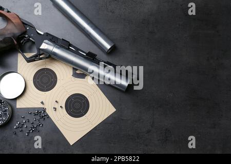 Flat lay composition with sport pistol on black table. Professional gun ...