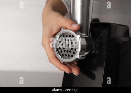Woman assembling electric meat grinder at black table, closeup Stock ...