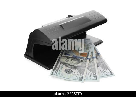 Modern currency detector with dollar banknotes and magnifying glass on ...