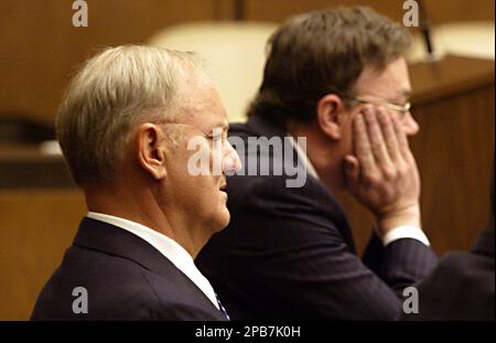 Millionaire technology guru John J. Donovan Sr., right, is comforted by ...