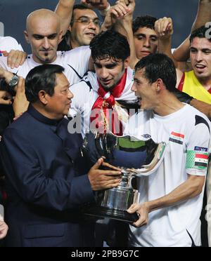Iraq's captain Younis Khalef, left, is lifted by teammates as they ...