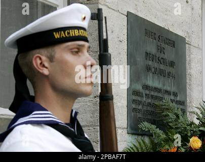 An honor guard stands beside a plaque commemorating the execution of ...