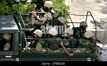 Pakistani paramilitary troops move towards a police training school on ...