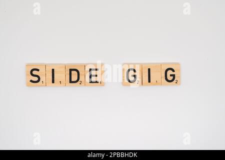 Wooden title spelling the words side hustle isolated on a white ...