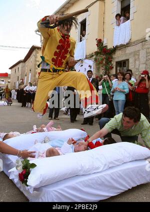 A man representing the devil and dressed in a traditional red and ...