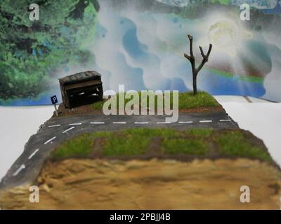 a close up of a diorama of a rice field scene and an old roadside house ...