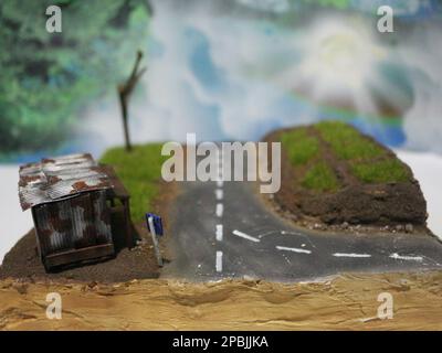 a close up of a diorama of a rice field scene and an old roadside house ...