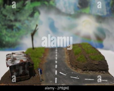 a close up of a diorama of a rice field scene and an old roadside house ...