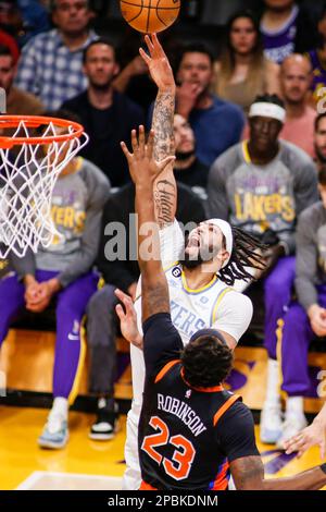 New York Knicks' Mitchell Robinson, center, dunks the ball as ...