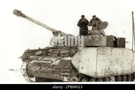 A German Panzer lV in Snow Camouflage with Turret Skirting approaches ...