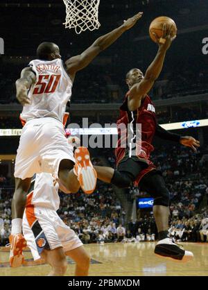 Charlotte Bobcats' Emeka Okafor (50) is guarded by Philadelphia 76ers ...
