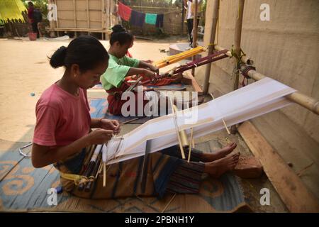 Karbi Anglong. 12th Mar, 2023. Women weave Jamborong (traditional bag ...