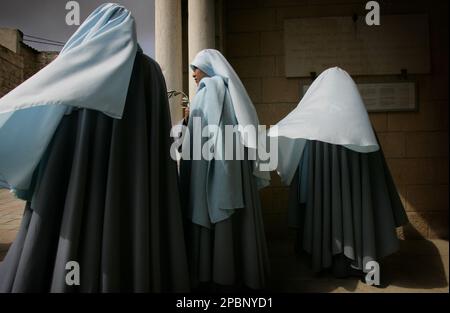 Catholic nuns hold olive branches as they participate in the ...