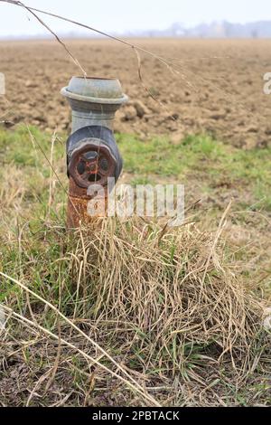 Rusty faucet in a field seen up close Stock Photo - Alamy