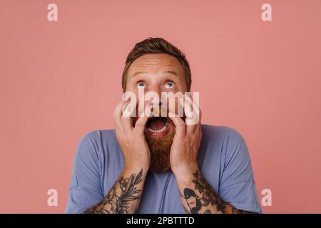 Ginger scared man with beard expressing surprise at camera isolated ...
