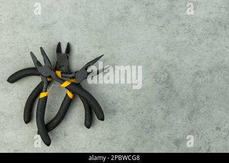 pliers set on the fray background, black different pliers Stock Photo ...