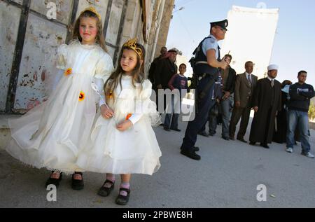 Jewish settler girls dressed in costumes hold hands as they walks ...